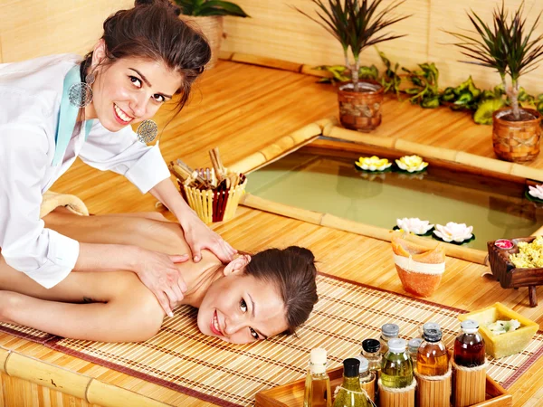 Woman getting massage in bamboo spa. - Stock Image - Everypixel