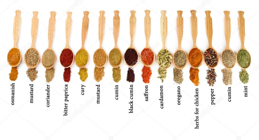 Many different spices with their name in wooden spoons isolated on ... Many different spices with their name in wooden spoons isolated on ...