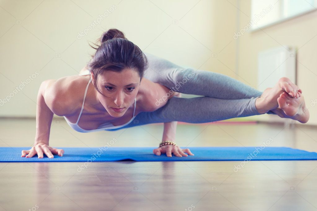 Beautiful young woman yoga workout Stock Photo by ©petrograd99 27211067