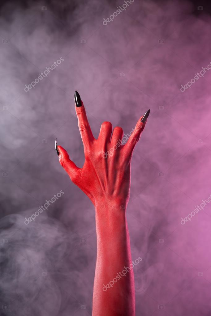Spooky devil hand showing heavy metal gesture — Stock Photo © Elisanth ...