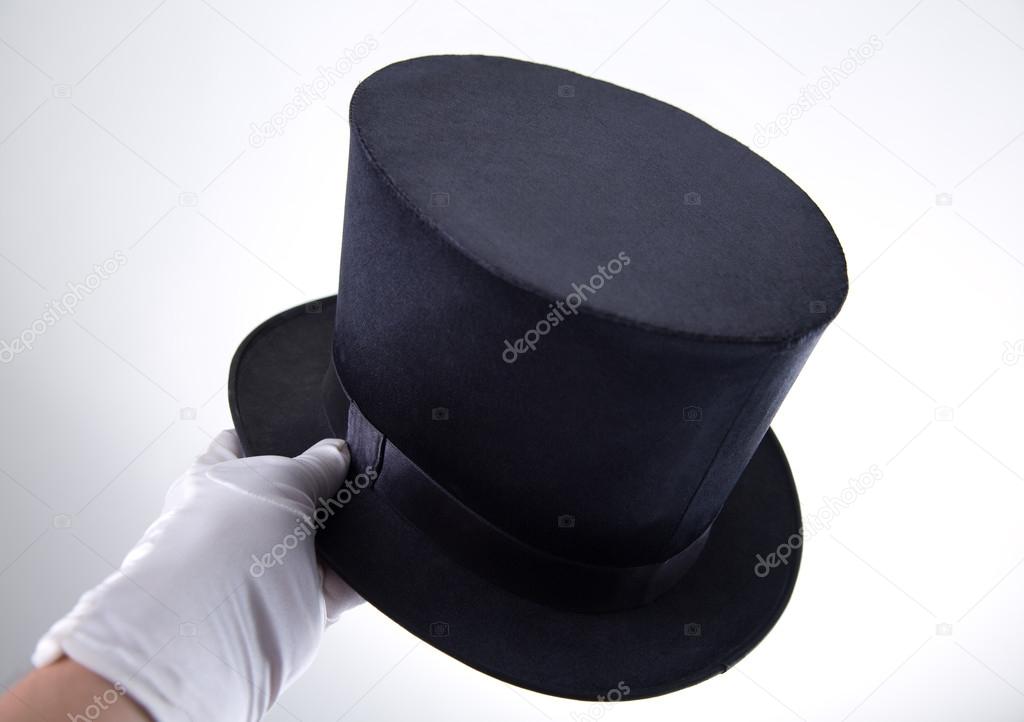 Male hand holding top hat — Stock Photo © Elisanth #47559793