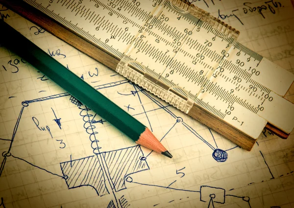 Pencil and a slide rule on the old page with the calculations in ...