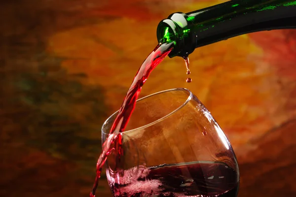 Red wine being poured into wine glass — Stock Photo © Observer #12045018