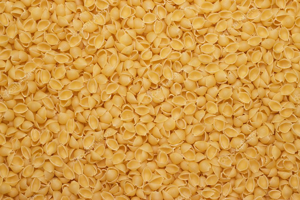 Dry uncooked macaroni texture background Stock Photo by ©garloon 19958947