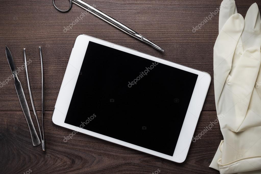 Table with tablet computer tools and gloves on it — Stock Photo ...