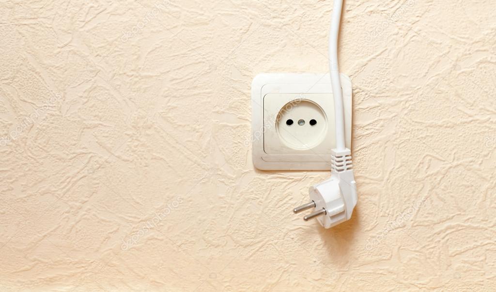 Electric wall plug at a beige wall Stock Photo by ©mettus 21089463