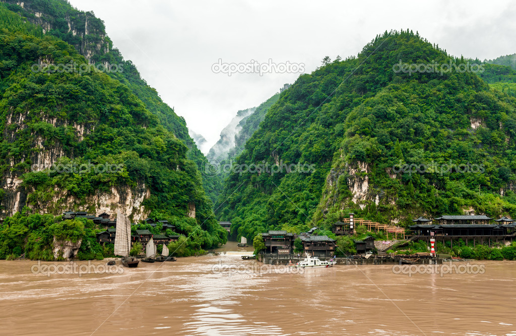 Chinese village and a boat on the Yangtze River in the mountains ...
