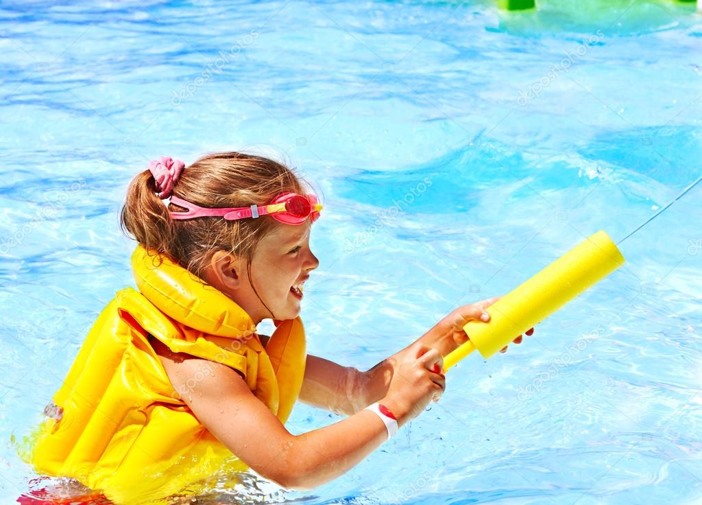 Child playing in swimming pool. — Stock Photo © poznyakov #23310964