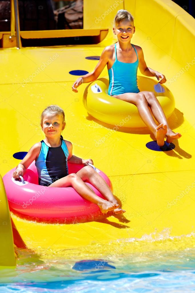 Child on water slide at aquapark. — Stock Photo © poznyakov #24042573