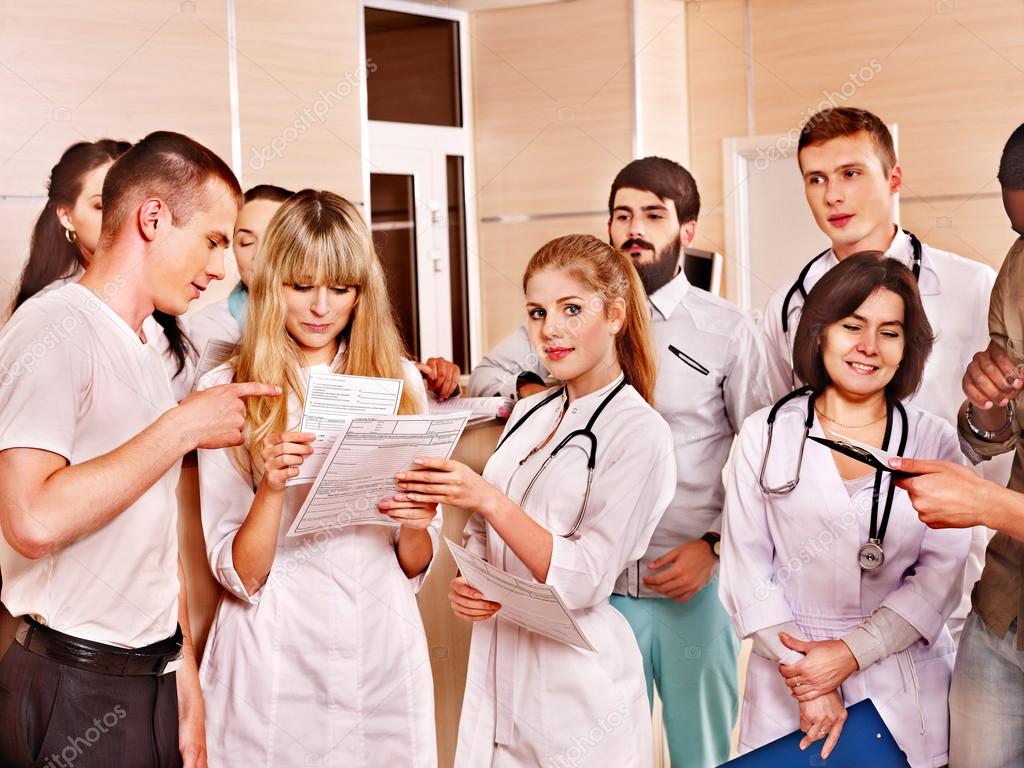 Group doctors at reception in hospital. Stock Photo by ©poznyakov 25257001