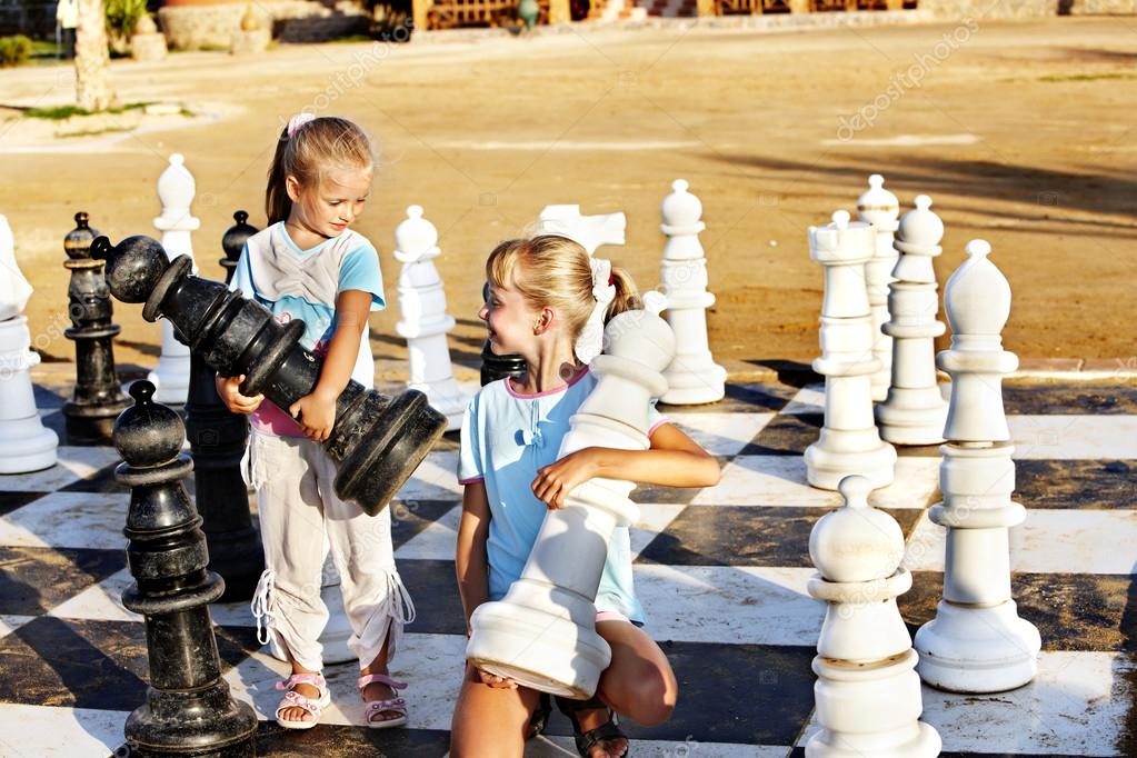 Children play chess outdoor. — Stock Photo © poznyakov #29031495