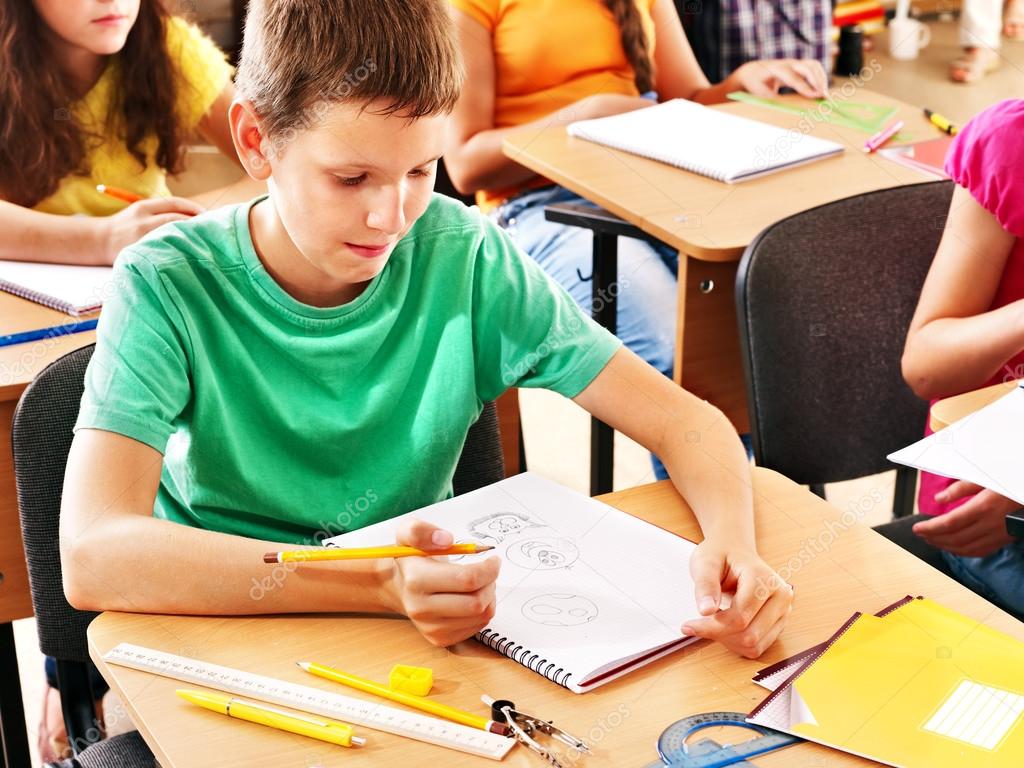 School child sitting in classroom. Stock Photo by ©poznyakov 30744095