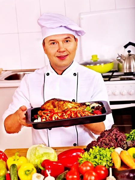 Man in chef hat cooking chicken - Stock Image - Everypixel
