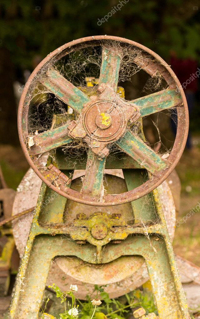 Rusty farm machinery with flywheel — Stock Photo © steveheap #42170251
