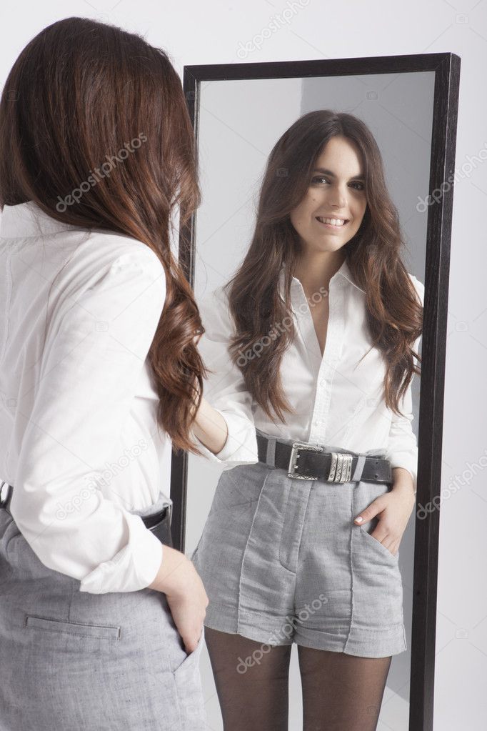 Real young woman looking in a mirror — Stock Photo © Immfocus #34126699