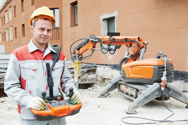Builder worker operating demolition machine — Stock Photo © kalinovsky ...