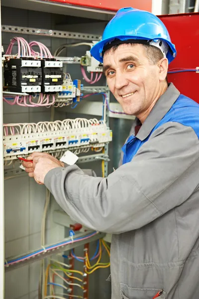 Happy electrician working at power line box — Stock Photo © kalinovsky ...