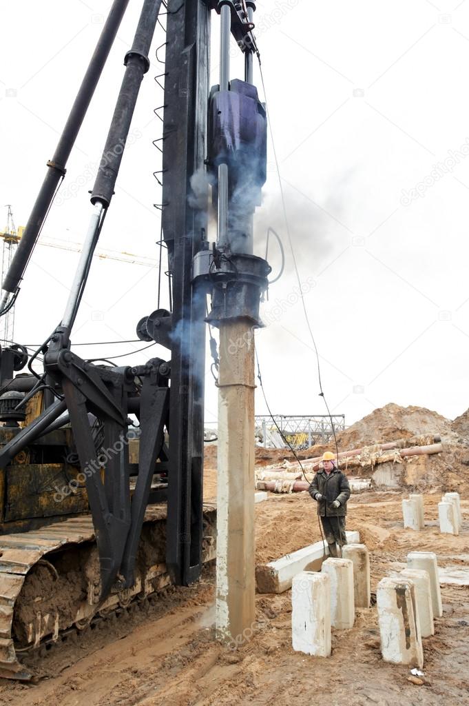 Builder operating impact pile machile Stock Photo by ©kalinovsky 18986715