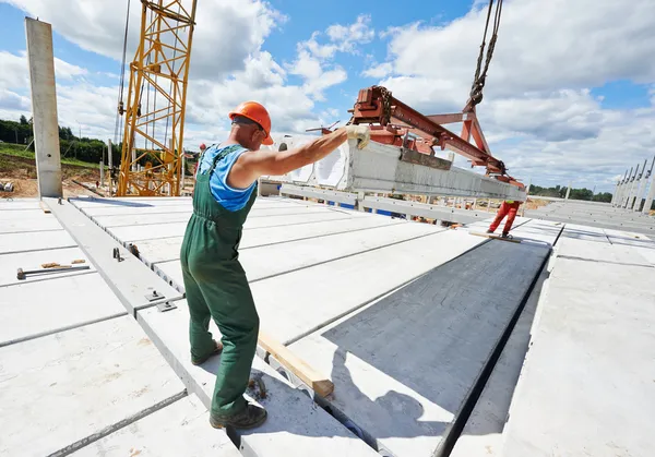 Builder worker installing concrete slab - Stock Image - Everypixel