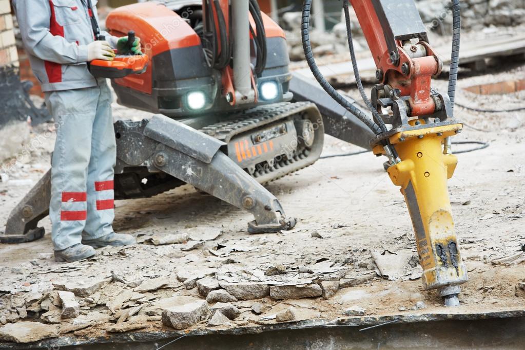 Builder worker operating demolition machine — Stock Photo © kalinovsky ...
