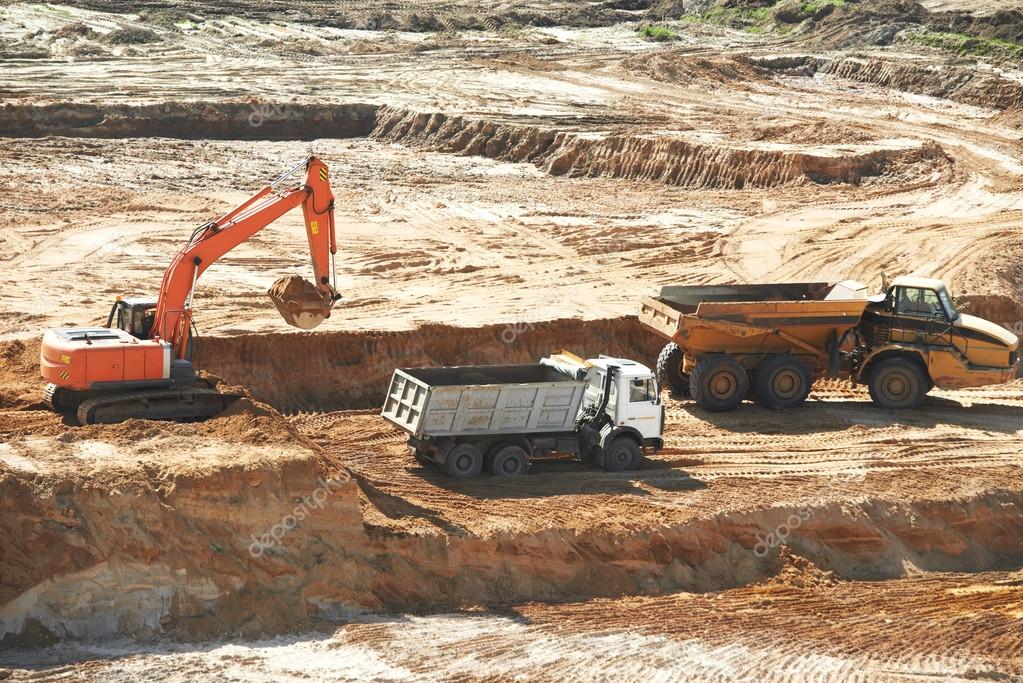 Excavator loading dumper truck Stock Photo by ©kalinovsky 32582091