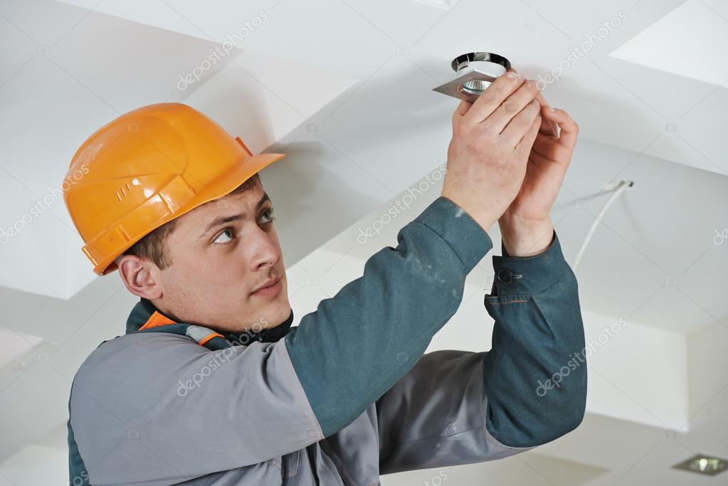 Electrician at spot light installation — Stock Photo © kalinovsky #41164979