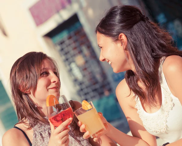 Two Young Women Cheering with Cold Drinks - Stock Image - Everypixel
