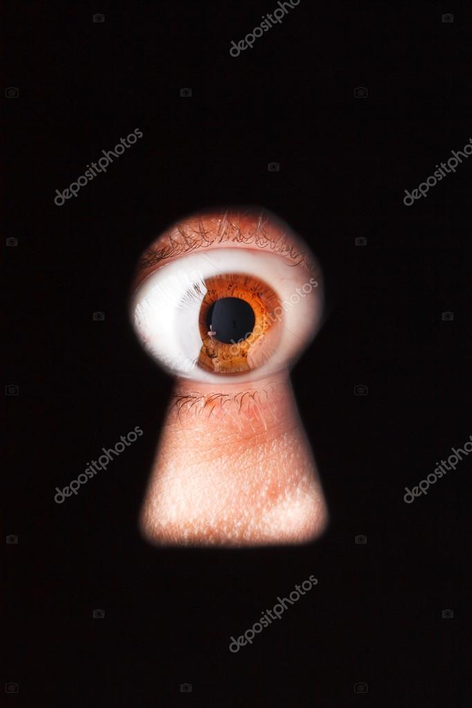Eye looking through a keyhole — Stock Photo © Shebeko #22087549