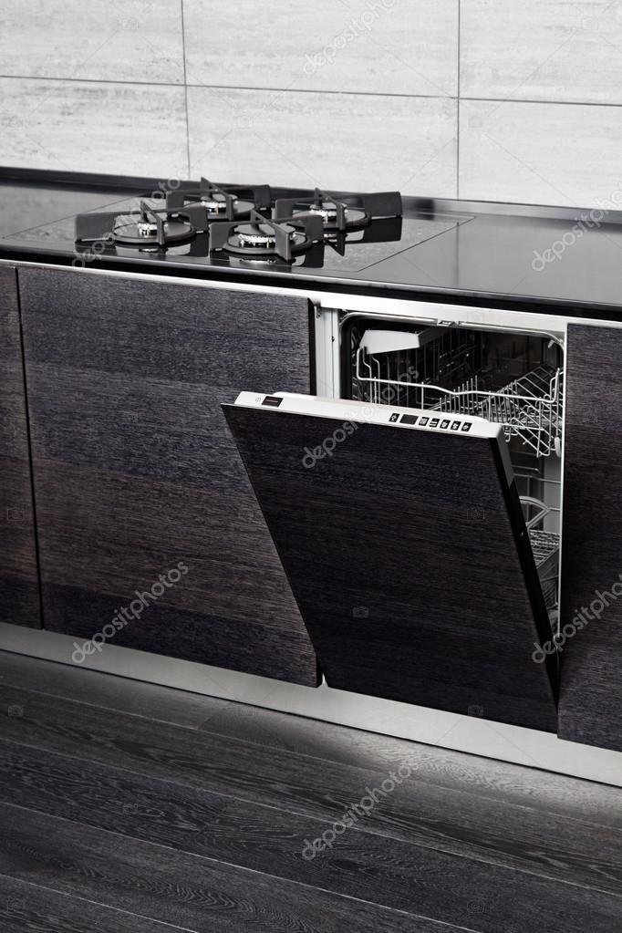 Open dish washer machine and gas-stove on black hardwood kitchen ⬇ ...