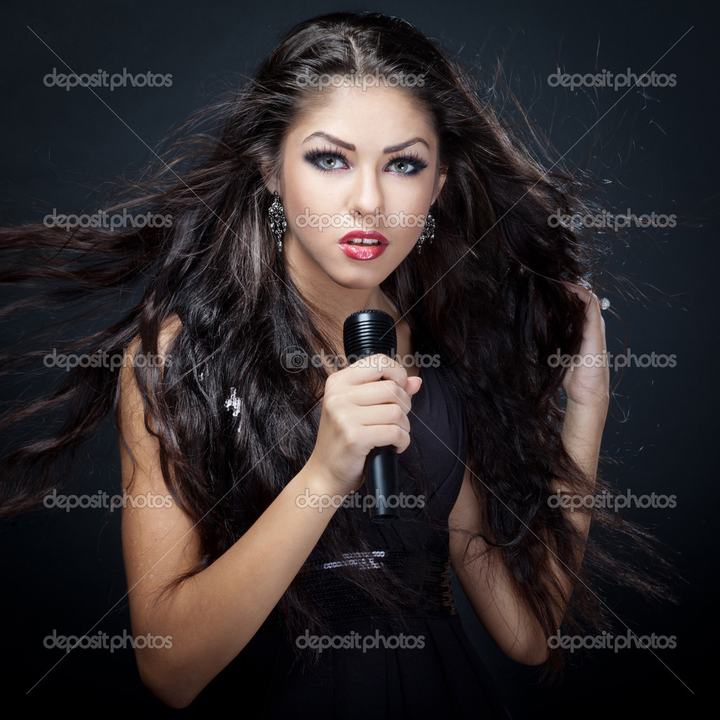 Beautiful young woman singer Stock Photo by ©repinanatoly 30463765