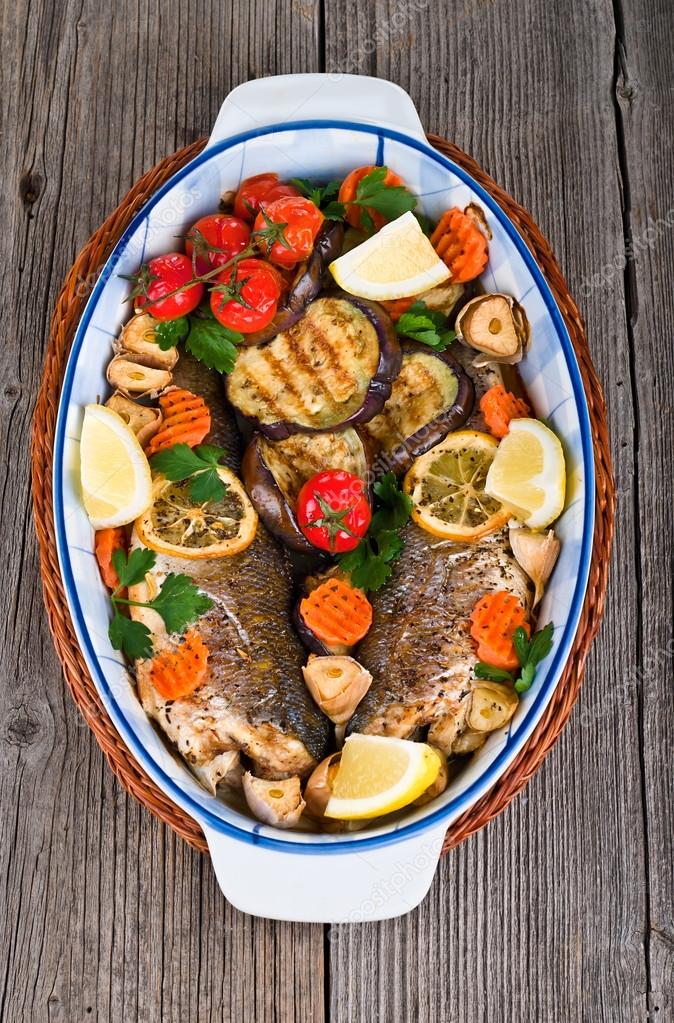 Main course: whole fried seabass served on wood Stock Photo by ©Am ...