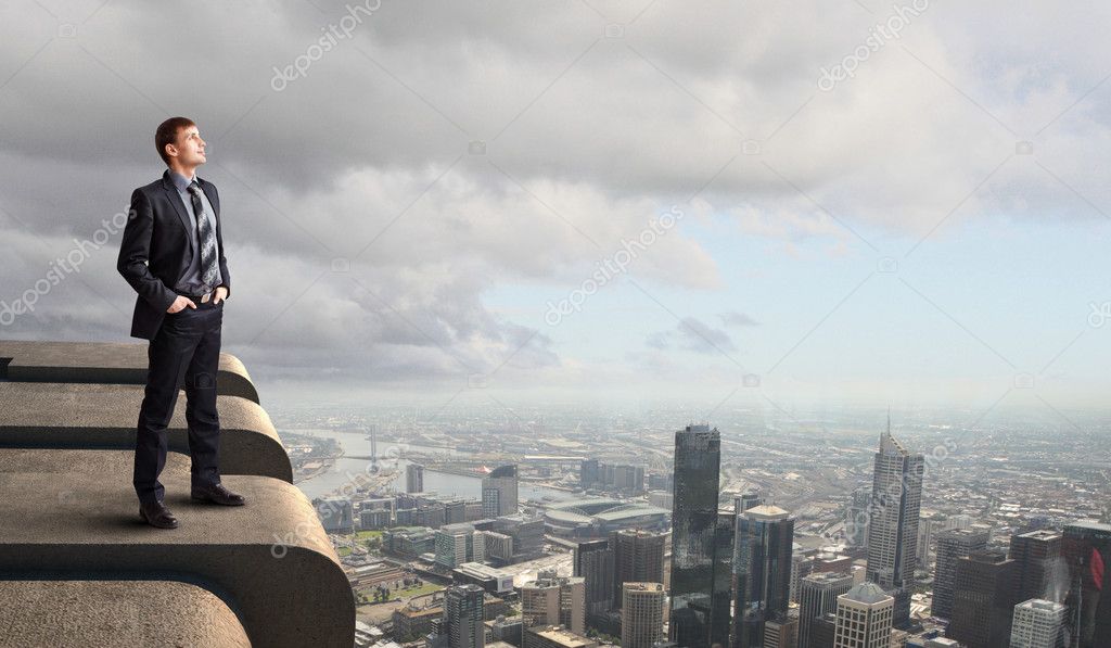 Successful young businessman standing against modern cityscape — Stock ... Successful young businessman standing against modern cityscape — Stock ...