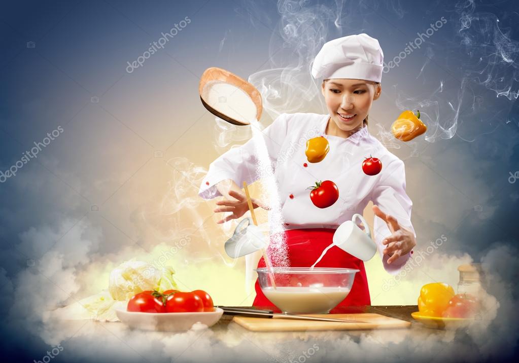 Asian female cooking with magic Stock Photo by ©SergeyNivens 21136867