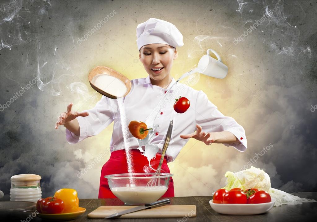 Asian female cooking with magic — Stock Photo © SergeyNivens #21137563