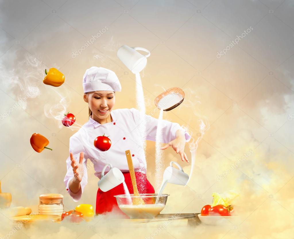 Asian female cooking with magic — Stock Photo © SergeyNivens #21137599