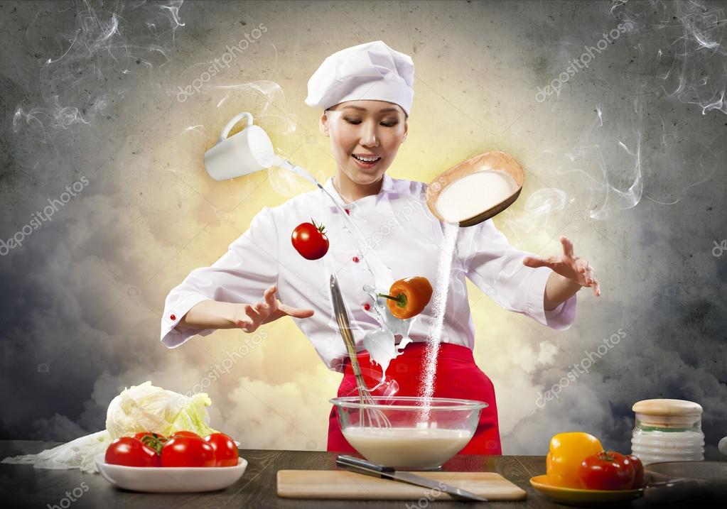 Asian female cooking with magic — Stock Photo © SergeyNivens #21137615