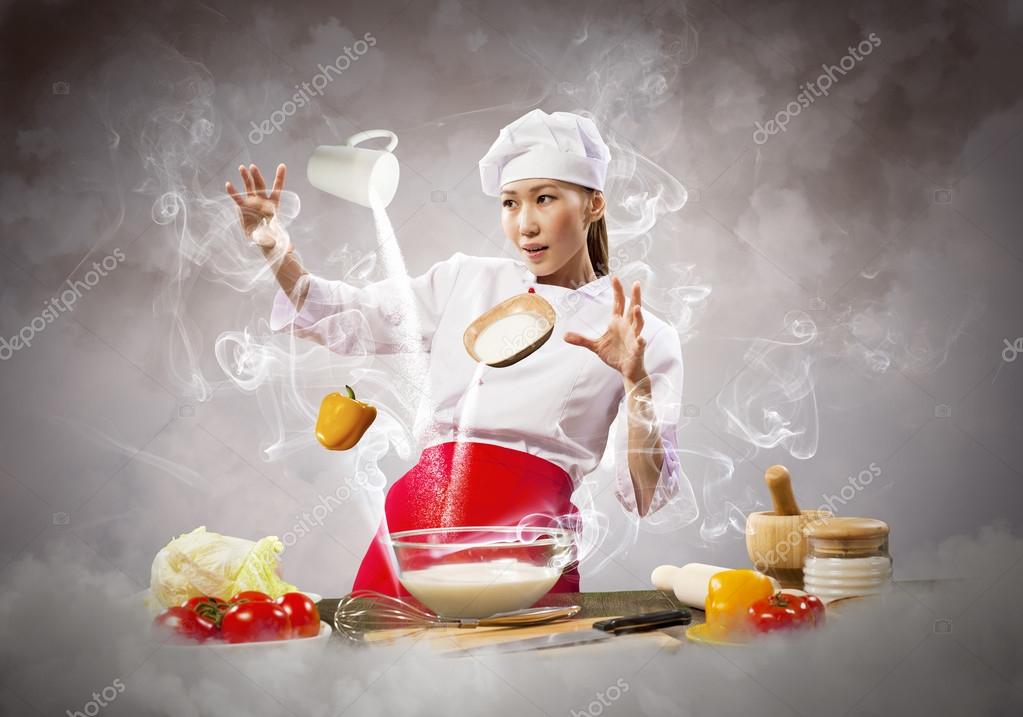 Asian female cooking with magic — Stock Photo © SergeyNivens #21137695