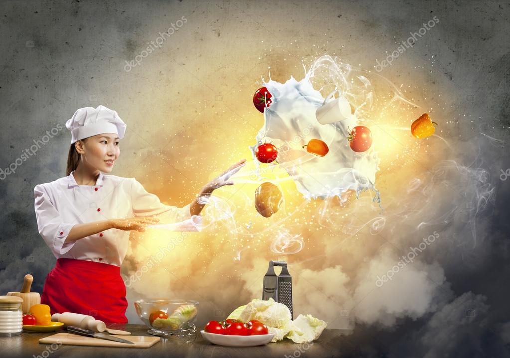 Asian female cooking with magic Stock Photo by ©SergeyNivens 21138031