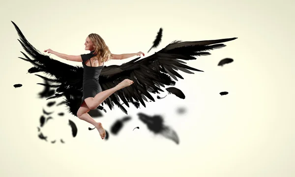 Woman floating on dark wings Stock Photo by ©SergeyNivens 26258379