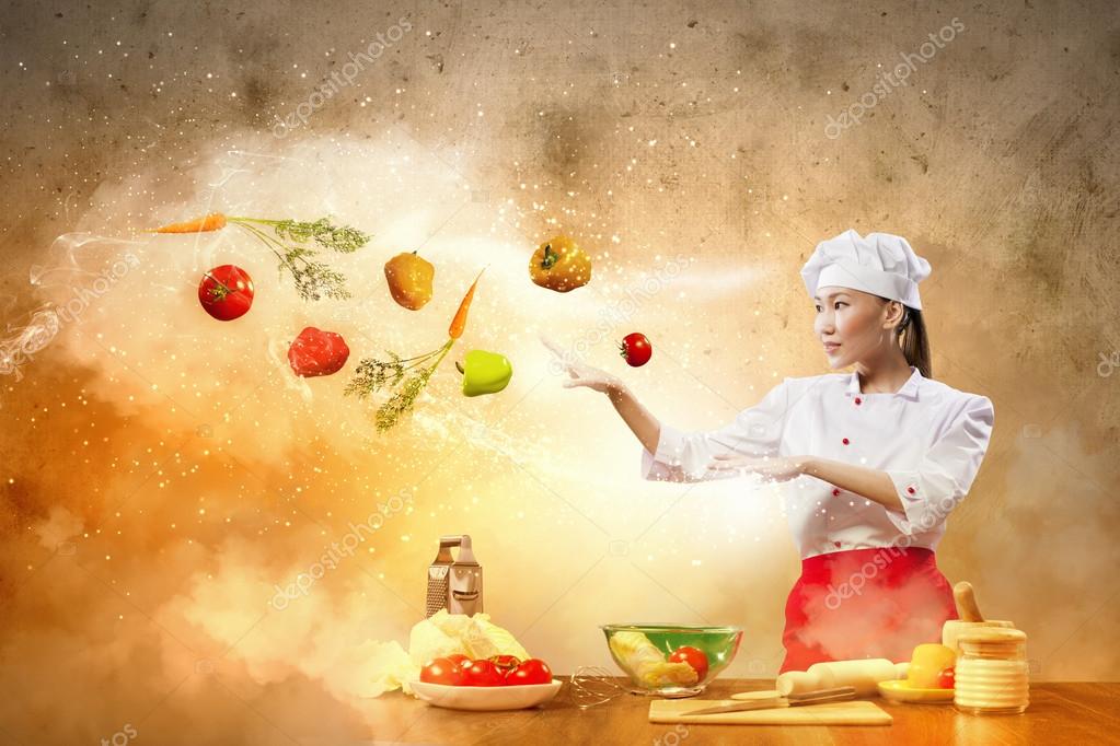 Asian female cooking with magic Stock Photo by ©SergeyNivens 29896085