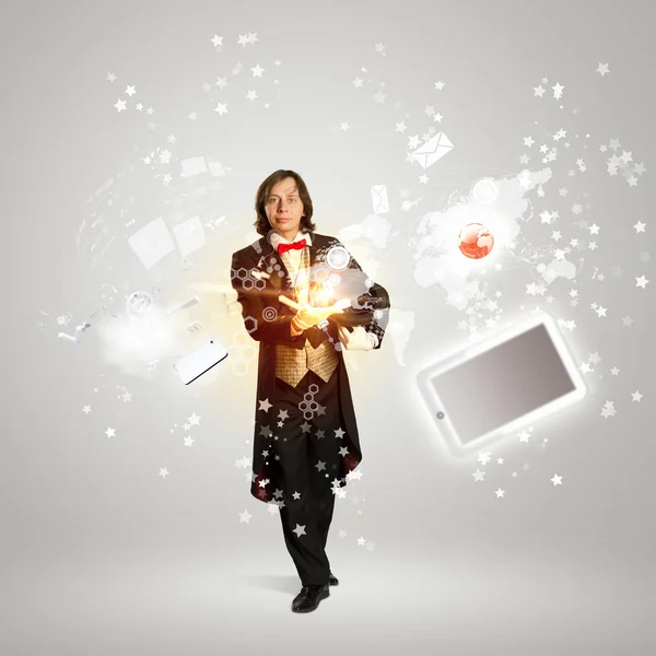 Magician and computer devices Stock Photo by ©SergeyNivens 31087307