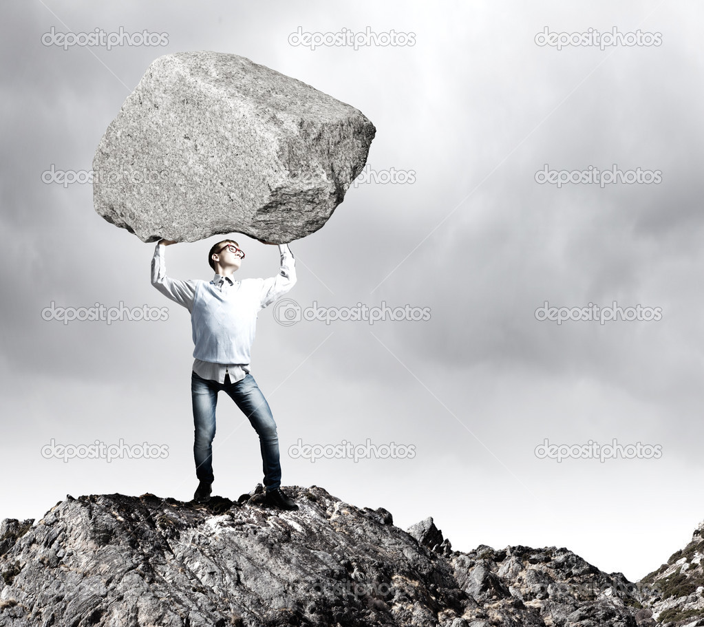 Guy lifting stone — Stock Photo © SergeyNivens #50193293