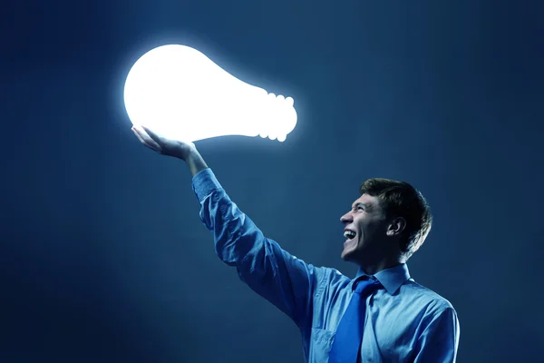 Man holding light bulb - Stock Image - Everypixel