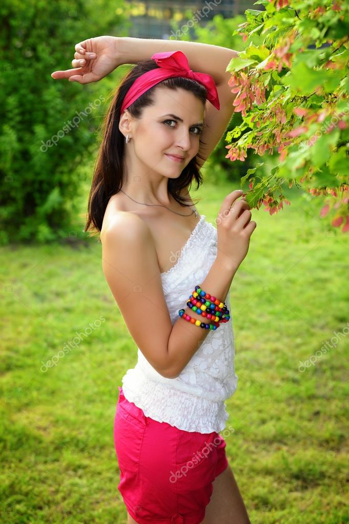 Beautiful girl in pin-up style near the tree — Stock Photo © Shenki ...