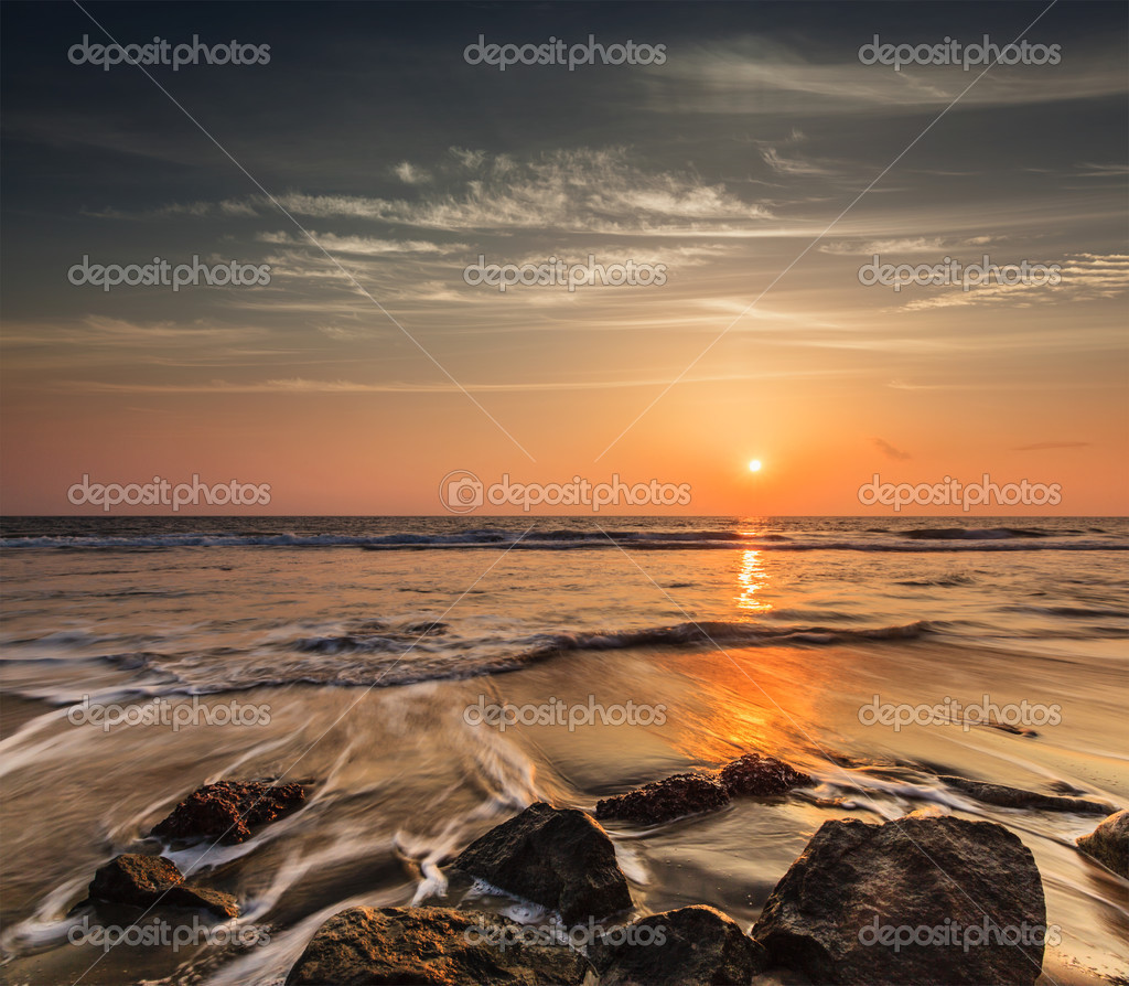 Waves and rocks on beach of sunset Stock Photo by ©DmitryRukhlenko 45274707