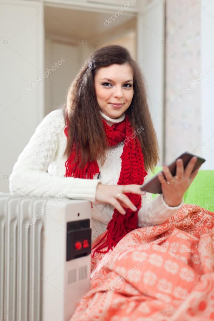 Woman reads e-reader near warm radiator Stock Photo by ©Jim_Filim 24183377