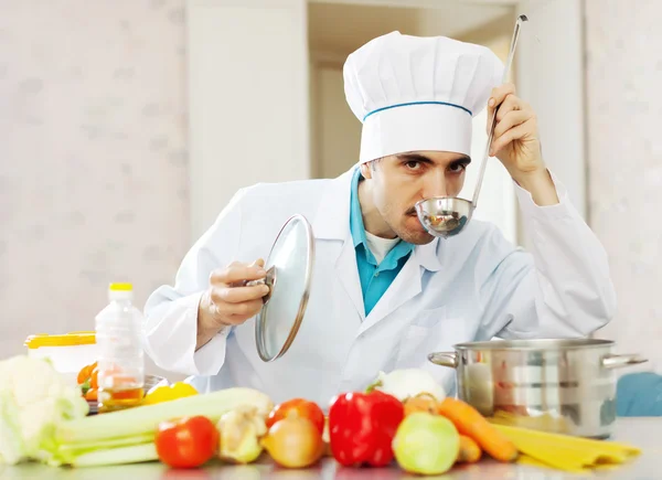 Caucasian male chef tasting soup - Stock Image - Everypixel
