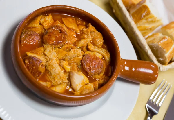 Spanish dish Callos - stewed beef tripe and chorizo served in clay bowl ...