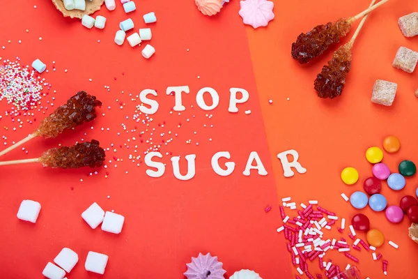 Mix of sweets and candy with sugar spread and written text in unhealthy ...