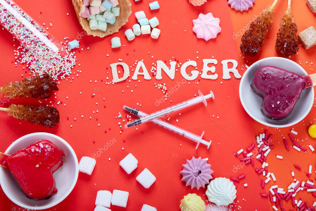 Mix of sweets and candy with sugar spread and written text in unhealthy ...